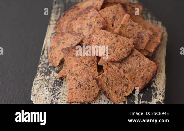 Crispy homemade brown bread chips with seeds and grains, salt, spices ...