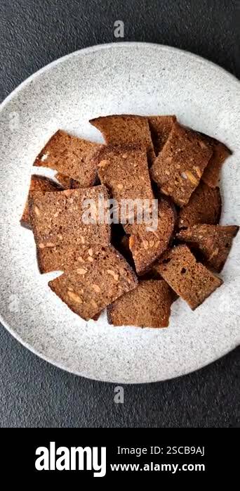 Crispy homemade brown bread chips with seeds and grains, salt, spices ...