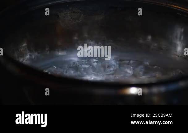 clear water boiling as it is heated, with bubbles rising rapidly to the ...
