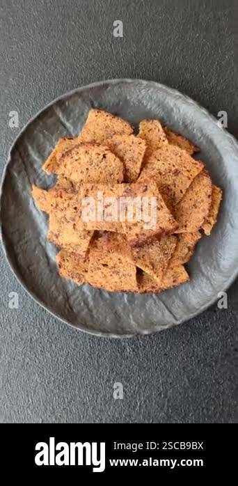 Crispy homemade brown bread chips with seeds and grains, salt, spices ...