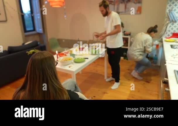 A relaxed atmosphere filled with friends happily cooking together and ...
