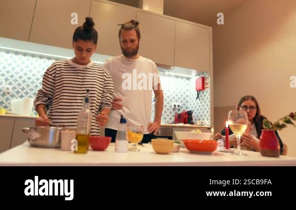 A lively and vibrant kitchen scene with friends happily cooking ...