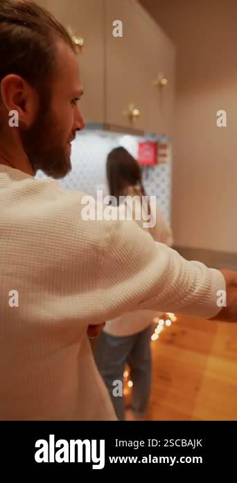 In a cozy kitchen scene, a man is happily cooking while sporting a ...