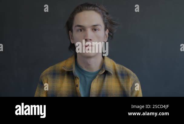 Portrait of shocked young man expressing surprise looking at camera on ...
