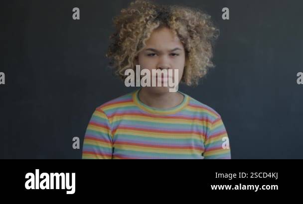 Portrait of unhappy African American woman shaking head meaning No on ...