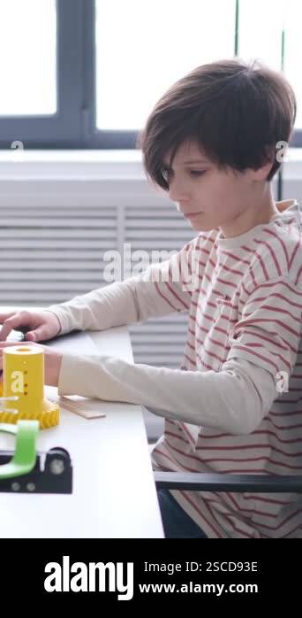Young Caucasian boy examine 3D printed mechanism detail, learning and ...