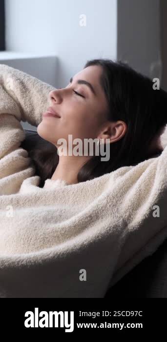 Lazy Caucasian young adult woman dreaming and resting on couch at home ...
