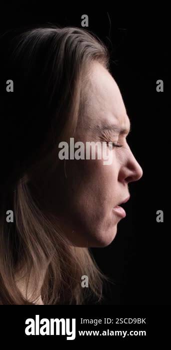 Profile portrait of a sad Caucasian middle aged woman in sorrow crying ...