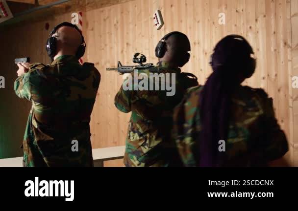 Team of soldiers wearing uniform in firing range doing shooting course ...