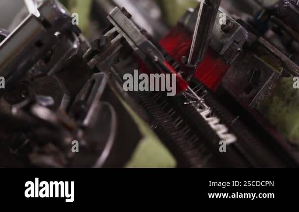 Close-up of industrial textile production in action, with white thread ...