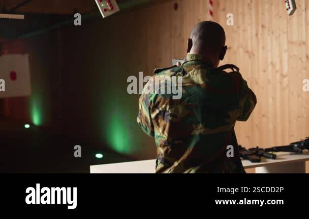 Man in firing range shooting targets with pistol doing celebratory hand ...