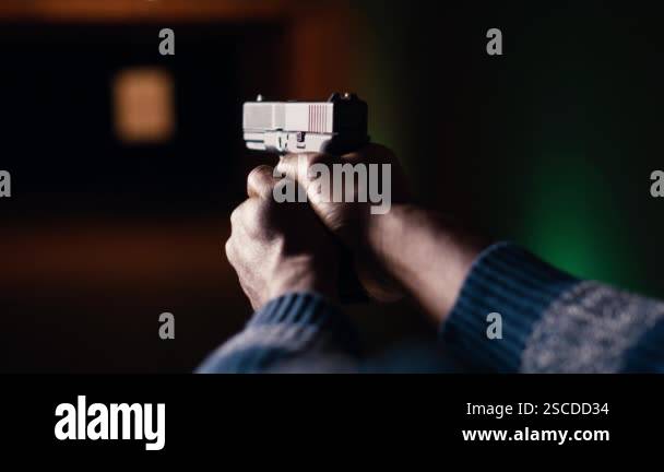 Shooting range client shoots with pistol, engaging targets at extended ...