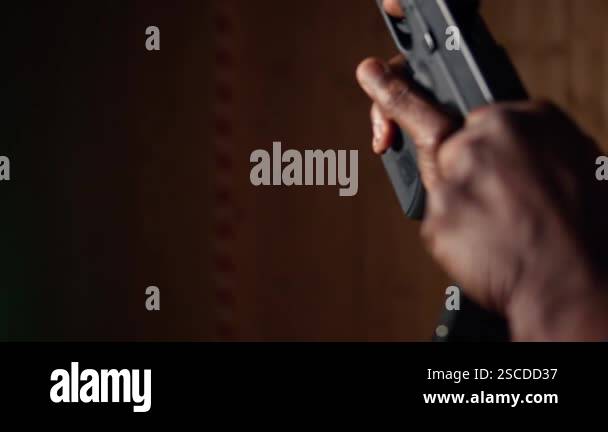 Man holding pistol enjoying recreational indoor shooting experience in ...