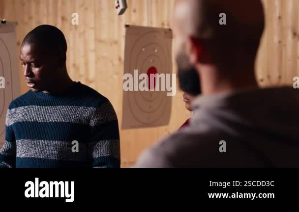 Shooting range safety officer demonstrating how to safely reload pistol ...