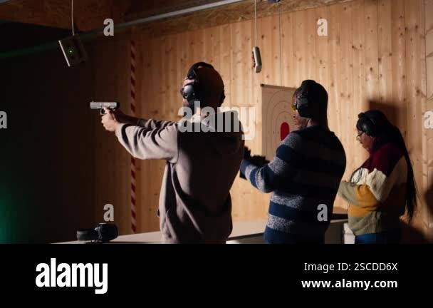 Group of friends in firing range doing recreational shooting activity ...
