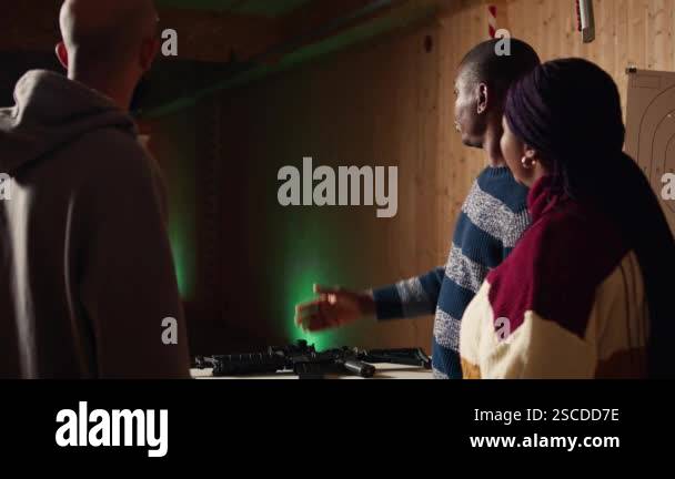 Shooting gallery safety officer explaining bullseye scoring system and ...