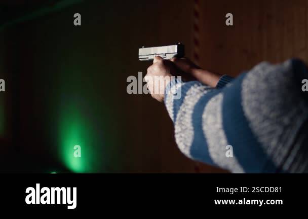 Firing range customer doing shooting activity with pistol, checking if ...