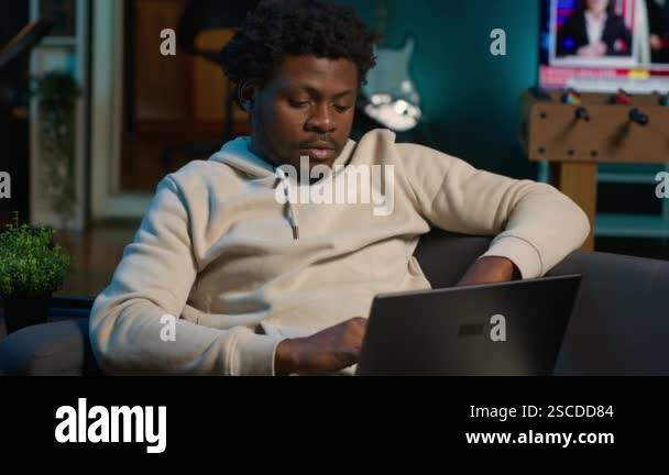 Black man does his research by reading articles and taking notes at ...