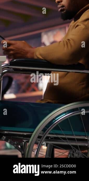 Vertical video Engineer with disability coding AI algorithms in inclusive startup office using ...