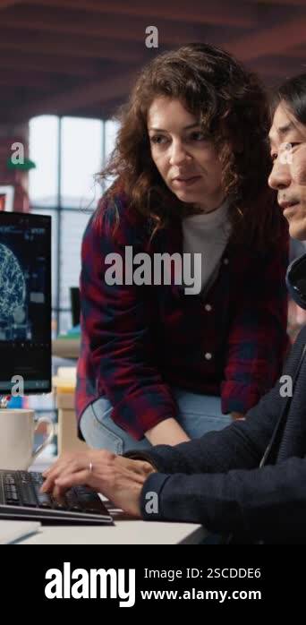 Vertical video Coworkers collaborating in AI tech agency providing software development services ...