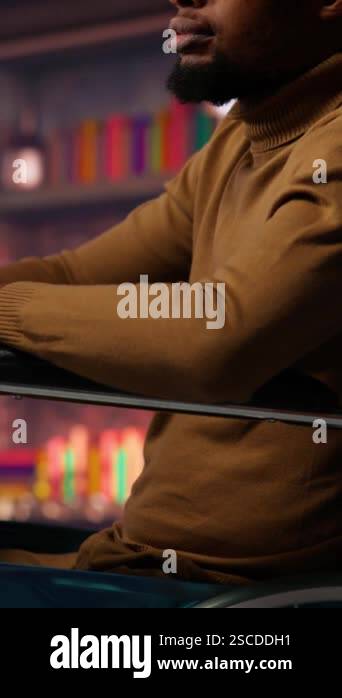 Vertical video Man in wheelchair working in inclusive AI tech agency providing software ...