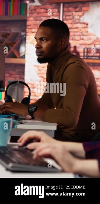 Vertical video Irked man punching startup office desk in frustration ...