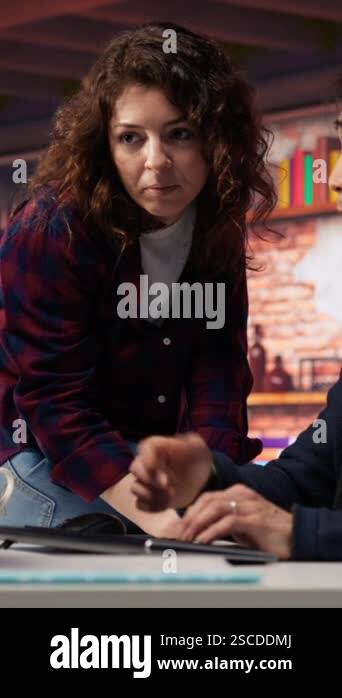 Vertical video Coworkers collaborating in AI tech agency providing software development services ...