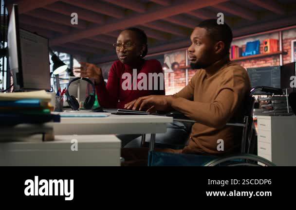 Manager coming to inclusive startup office employee in wheelchair desk ...