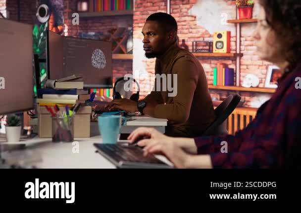 Irked man punching startup office desk in frustration struggling to fix application errors ...