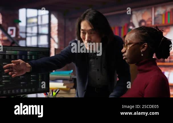 Artificial intelligence startup company manager overseeing programmer building application ...