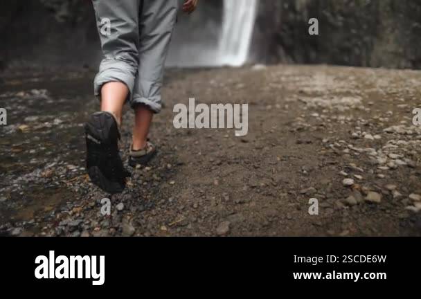 Person walking waterfall path on Bali island, Indonesia. Tourist legs ...