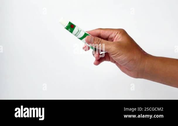 Hand holding genoint. Genoint is an eye drop, eye ointment and skin ...