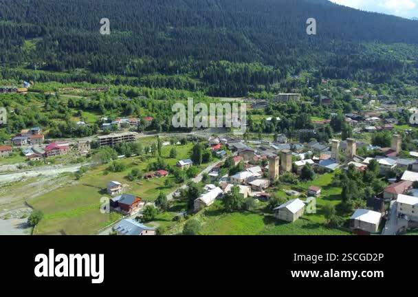 Lush green vegetation surrounds town of Mestia, located in valley and ...