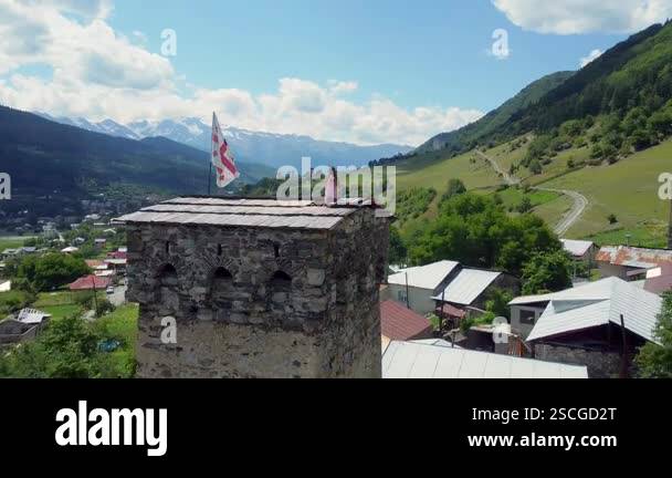 Caucasus Mountains and Svan Towers Surround Tourist Standing On Roof Of ...