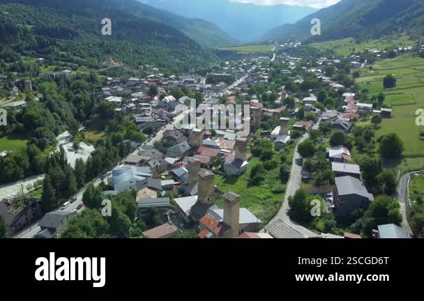 Lush green vegetation surrounds town of Mestia, located in valley and ...