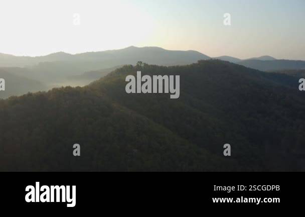 Beautiful sunrise on the mountain in winter. The sun shines down on a ...