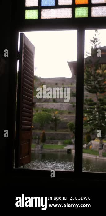 View from an open wooden window in a historic palace in Bali, Indonesia ...