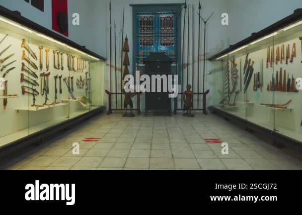 A museum display featuring various traditional weapons and artifacts ...