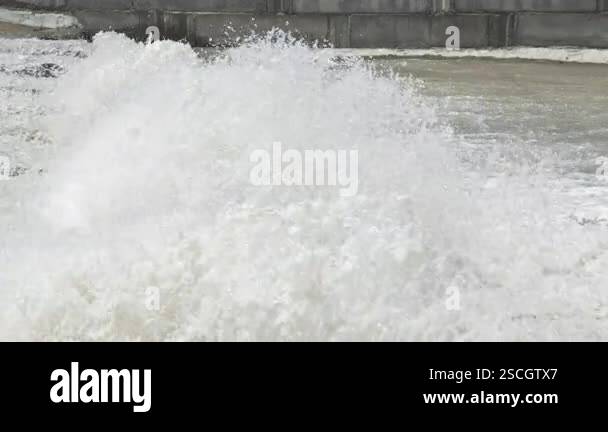 row of chute dentate blocks in concrete water spillway channel slope ...