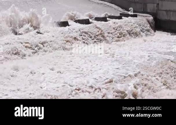 row of chute dentate blocks in concrete water spillway channel slope ...