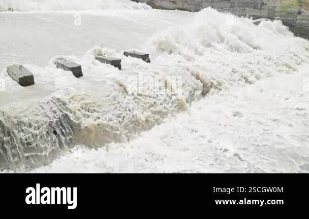 row of chute dentate blocks in concrete water spillway channel slope ...