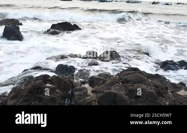 Footage of ocean waves motion splashing the beach rocks. Waves of water ...