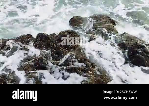 Footage of ocean waves motion splashing the beach rocks. Waves of water ...