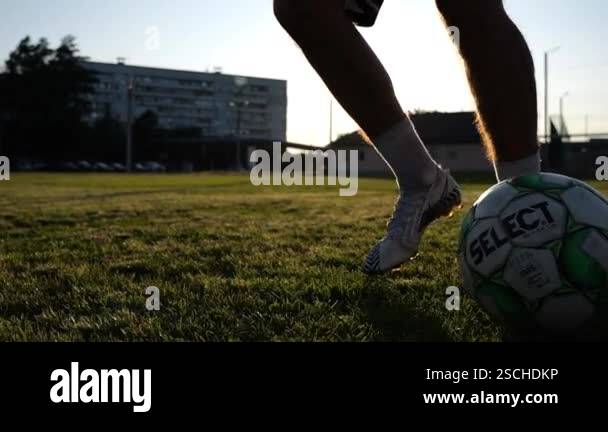 Male feet of professional footballer shows tricks with ball while ...