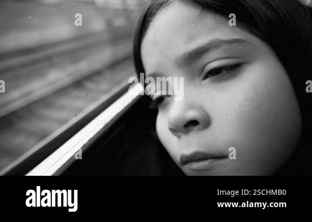 Sad depressed child gazing at view from train's window from passenger ...