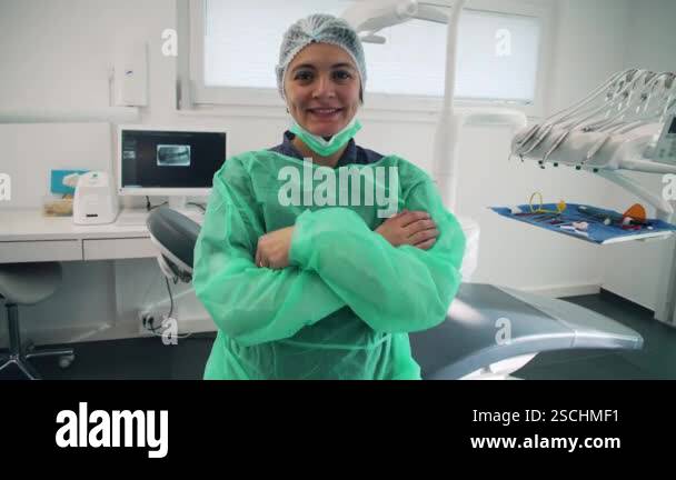 Happy Female Dentist crossing arms posing for camera inside bright ...