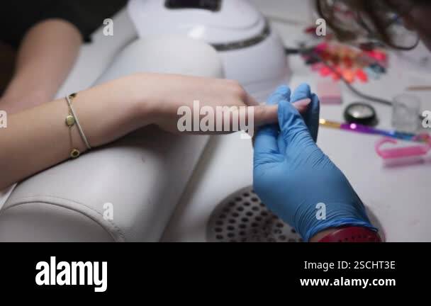 A highquality professional manicure session takes place in a stylish ...