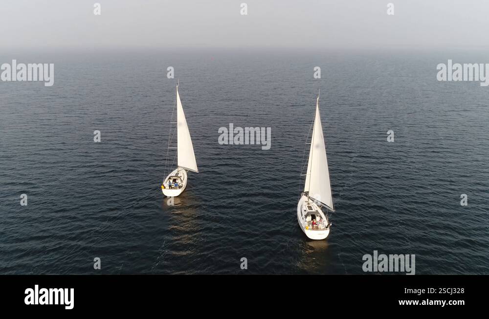 Aerial view of two sloop vessels are sailing boats with single mast 4k ...