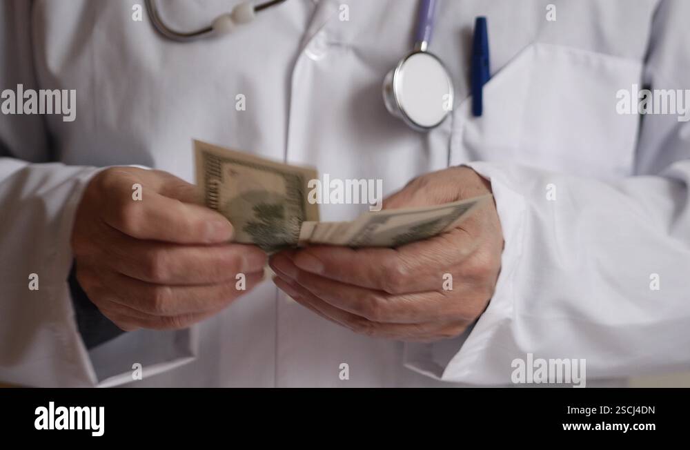 Male Medical Doctor Counting Money Stock Video Footage - Alamy