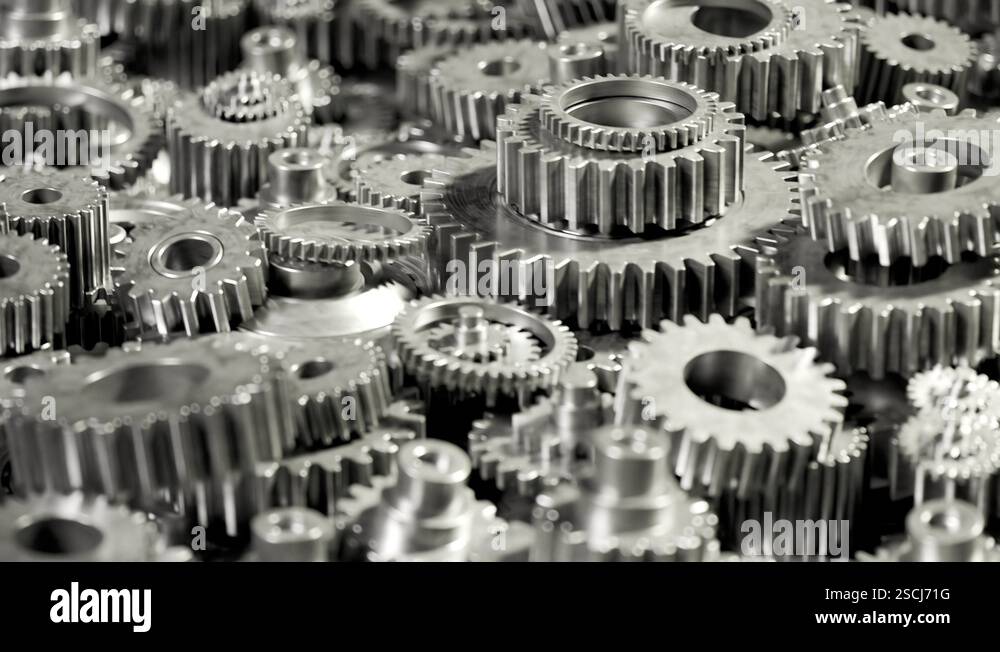 Seamless loop animation of a bunch of dark metallic gears laying on the ...